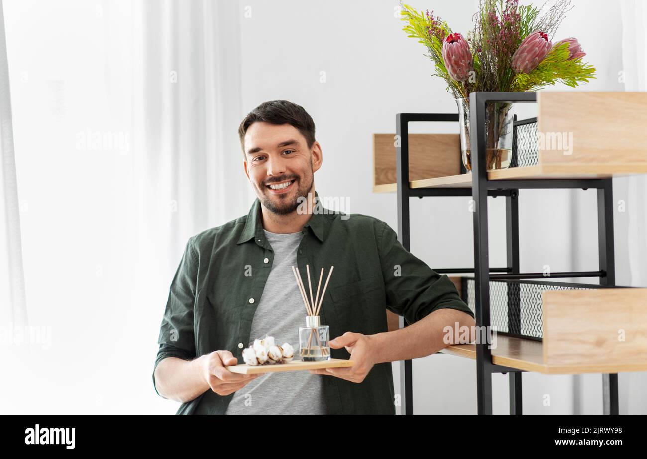 man placing aroma reed diffuser to shelf home Stock Photo - Alamy