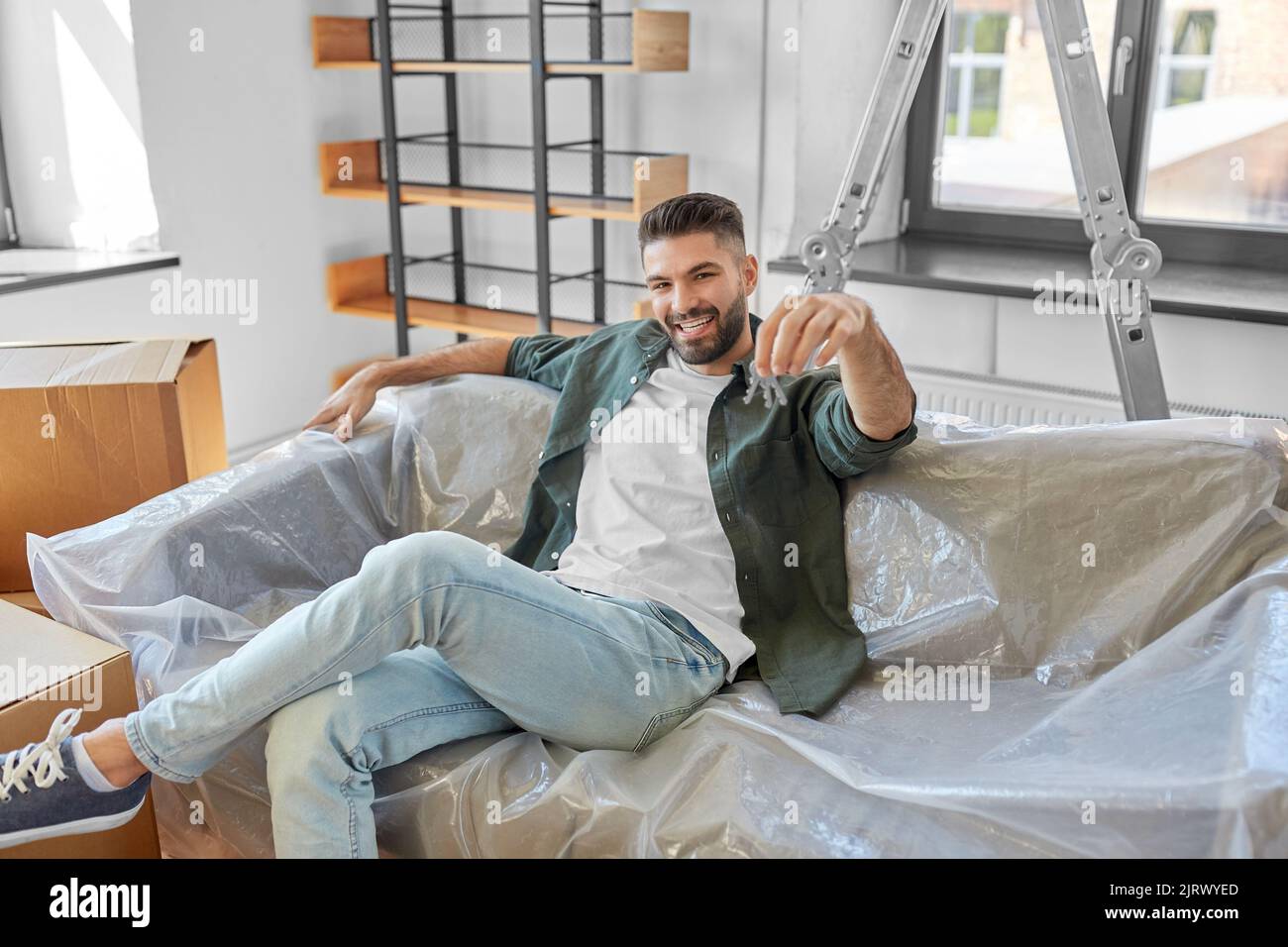 man with house keys and boxes moving to new home Stock Photo - Alamy
