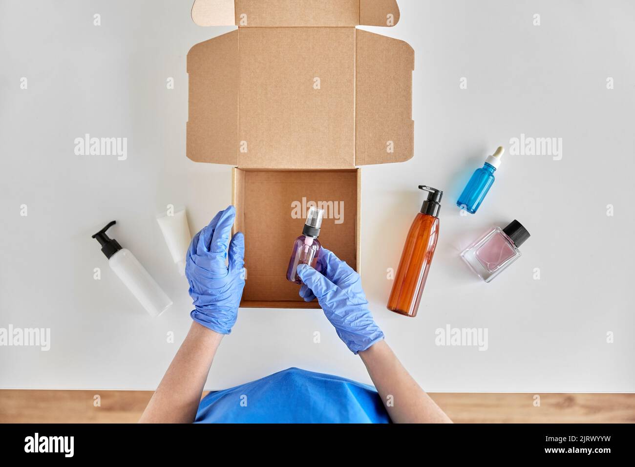Hands in gloves packing parcel hi-res stock photography and images - Alamy