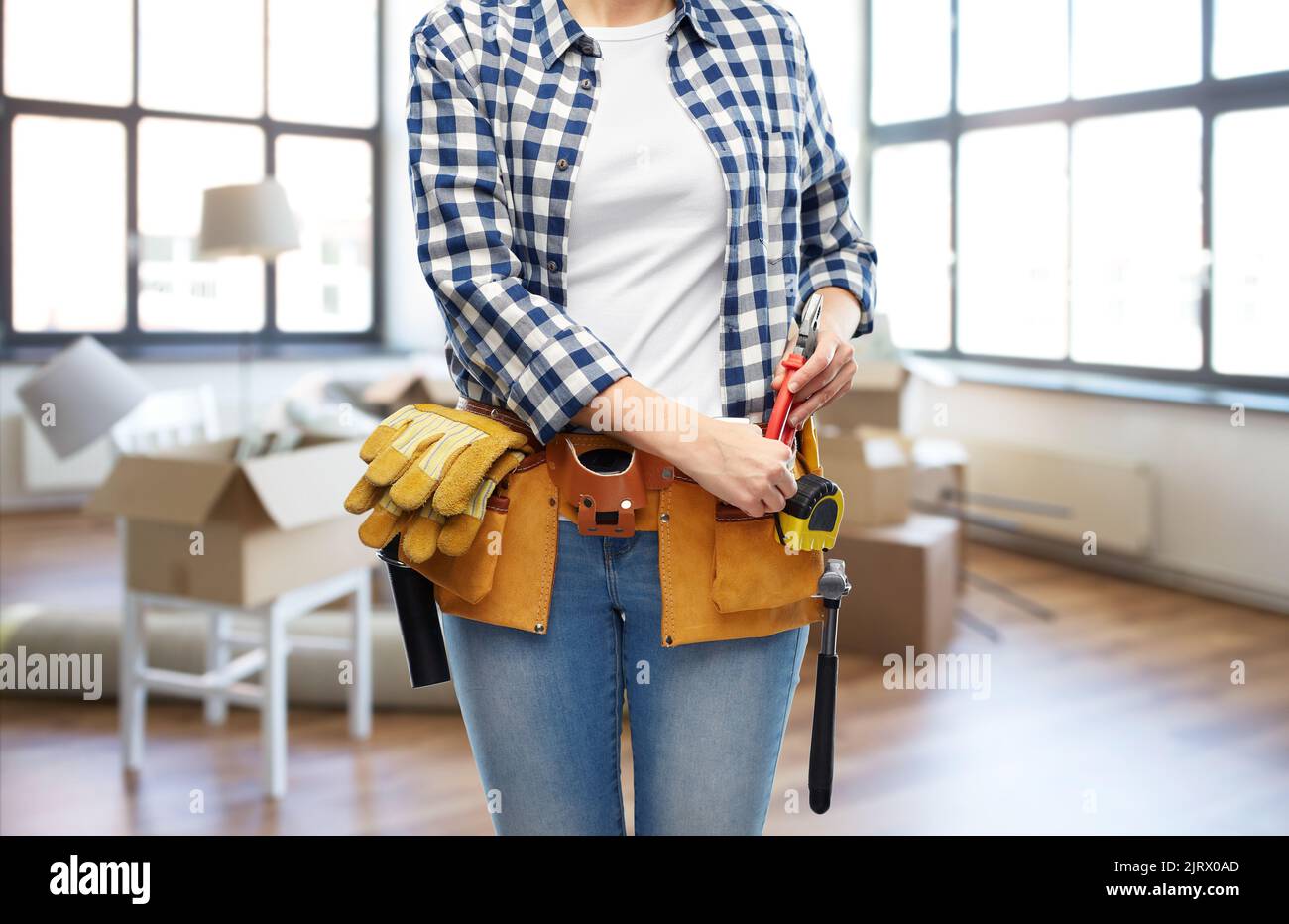 woman with working tools on belt at new home Stock Photo - Alamy