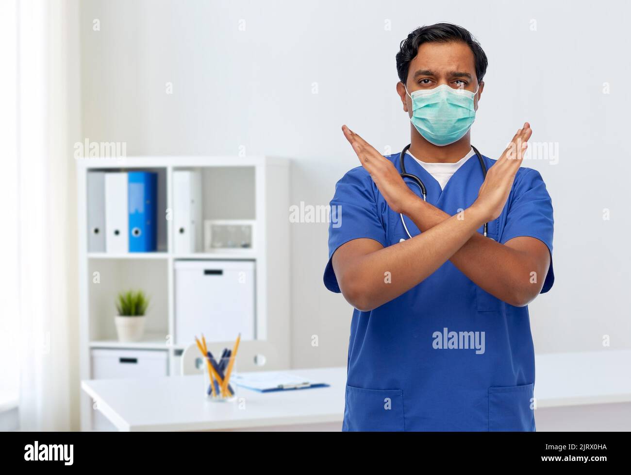 indian male doctor mask showing refusal gesture Stock Photo - Alamy