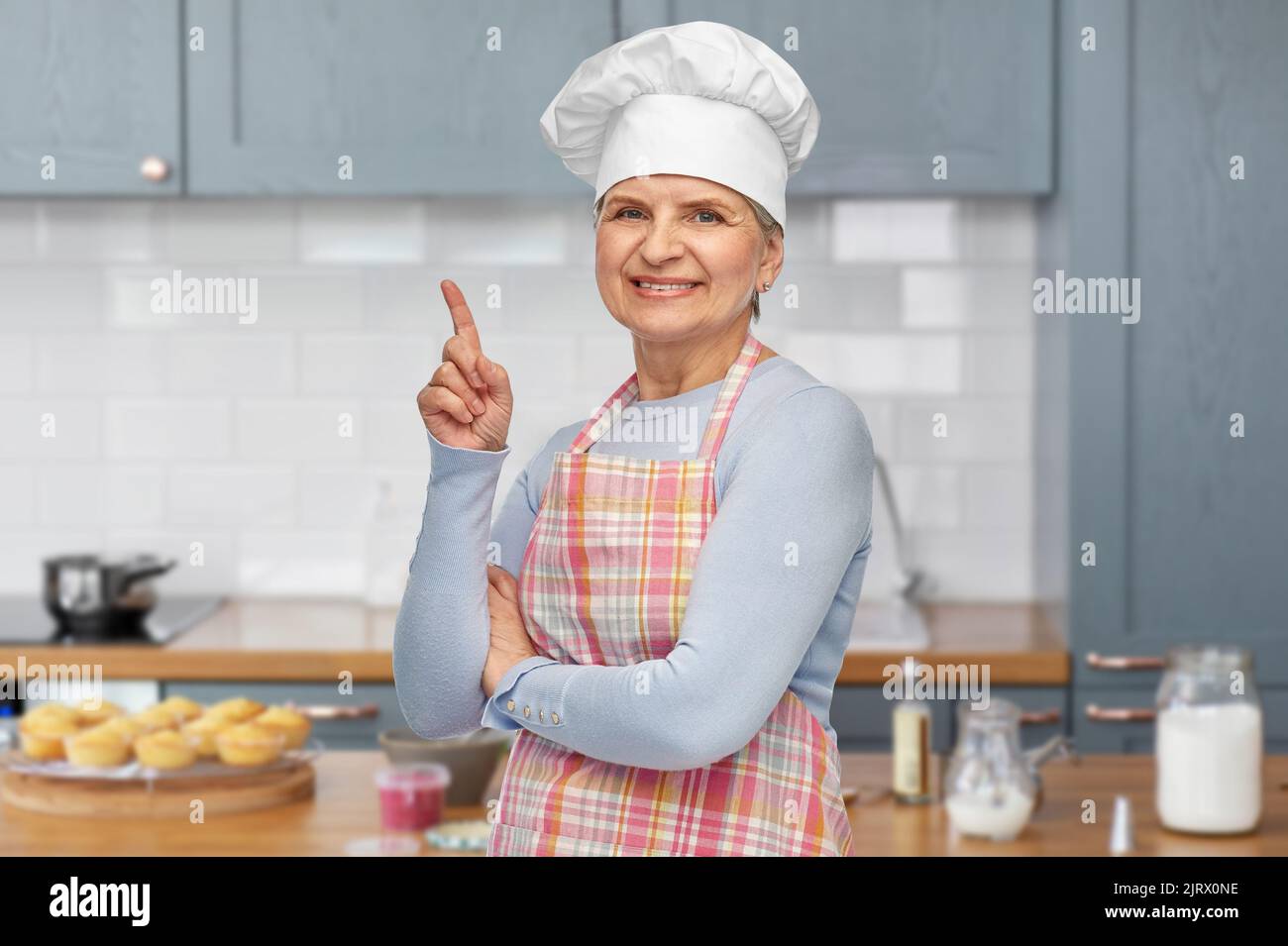 Smiling senior cook pointing finger hi-res stock photography and images ...