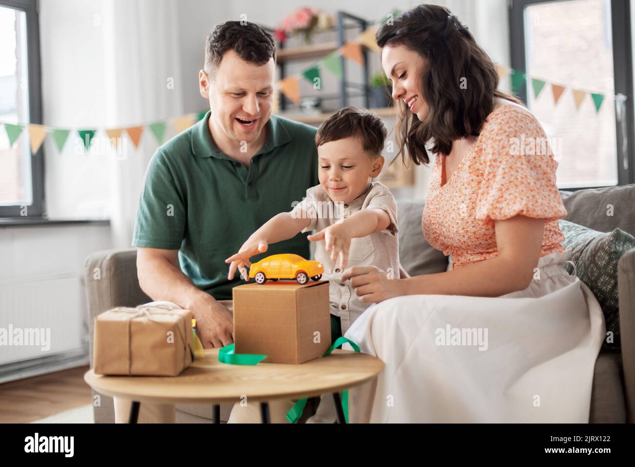 happy family opening birthday presents at home Stock Photo - Alamy