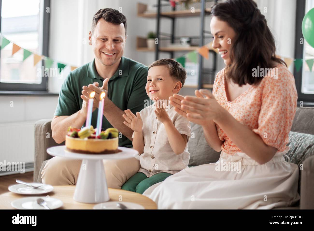 happy family with birthday cake at home Stock Photo - Alamy