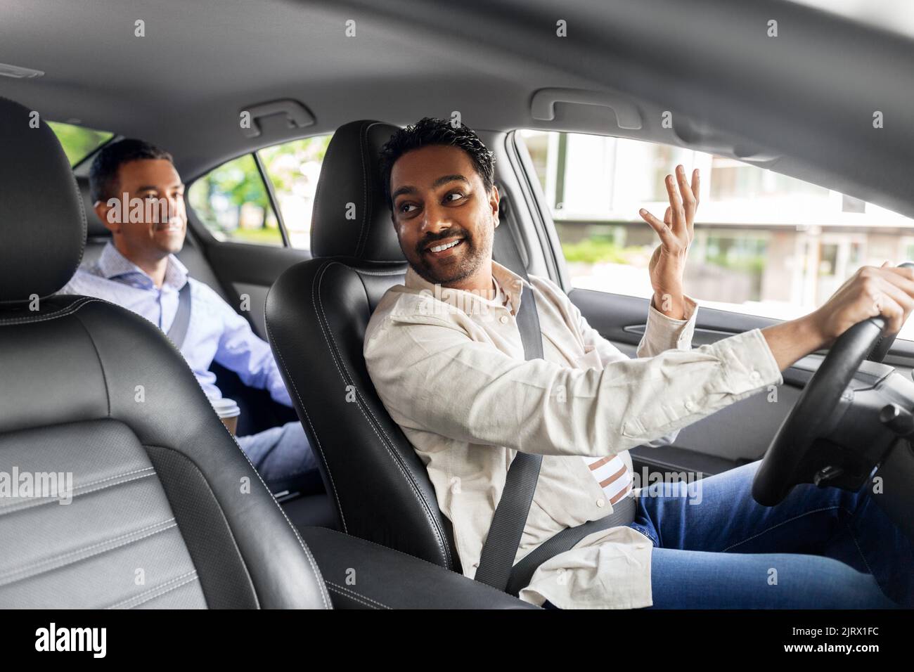 middle aged male passenger talking to car driver Stock Photo - Alamy