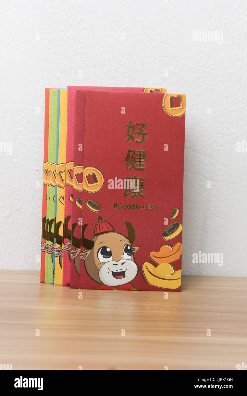 A vertical closeup of traditional gift of red pockets (Hong bao) for ...