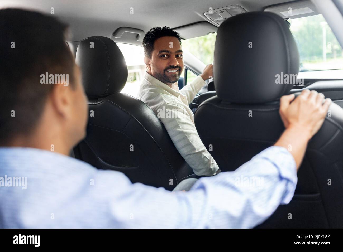 middle aged male passenger talking to car driver Stock Photo - Alamy