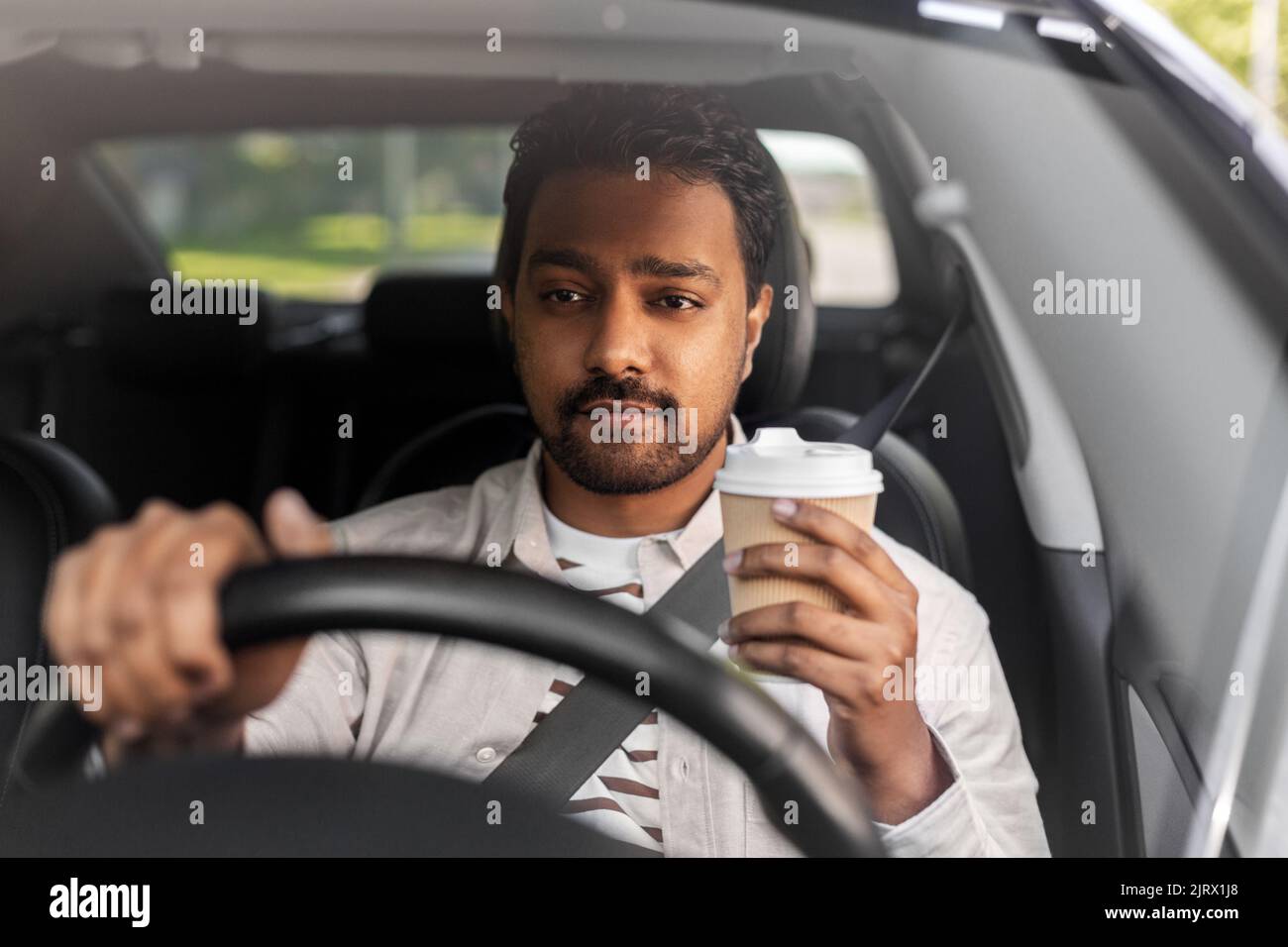 indian man or driver with coffee driving car Stock Photo - Alamy