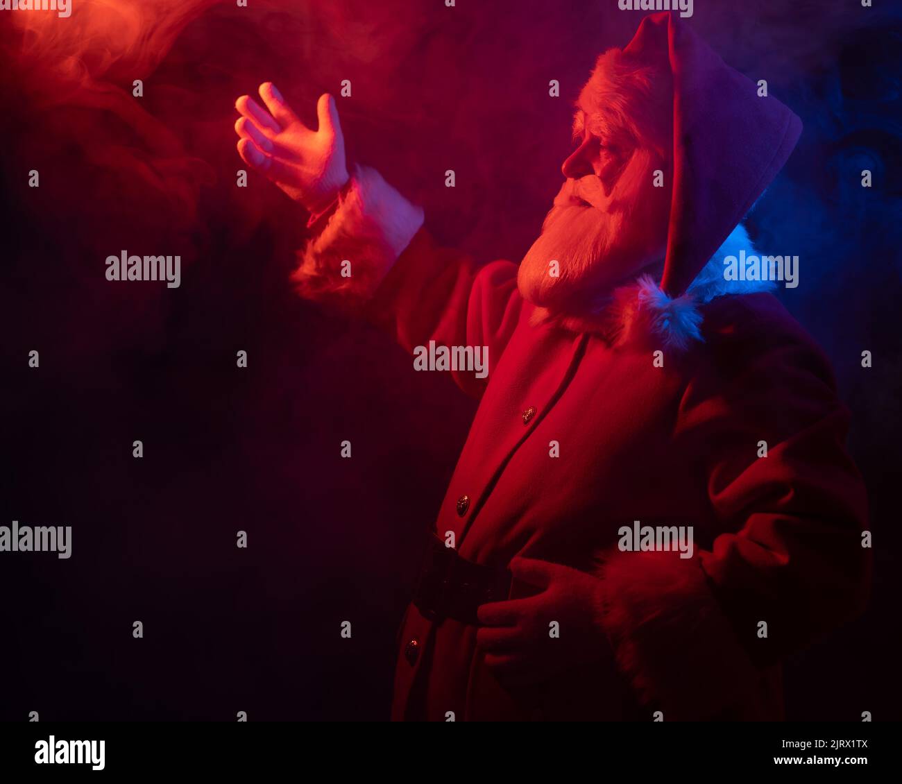 Santa Claus portrait in blue red neon light and smoke Stock Photo - Alamy