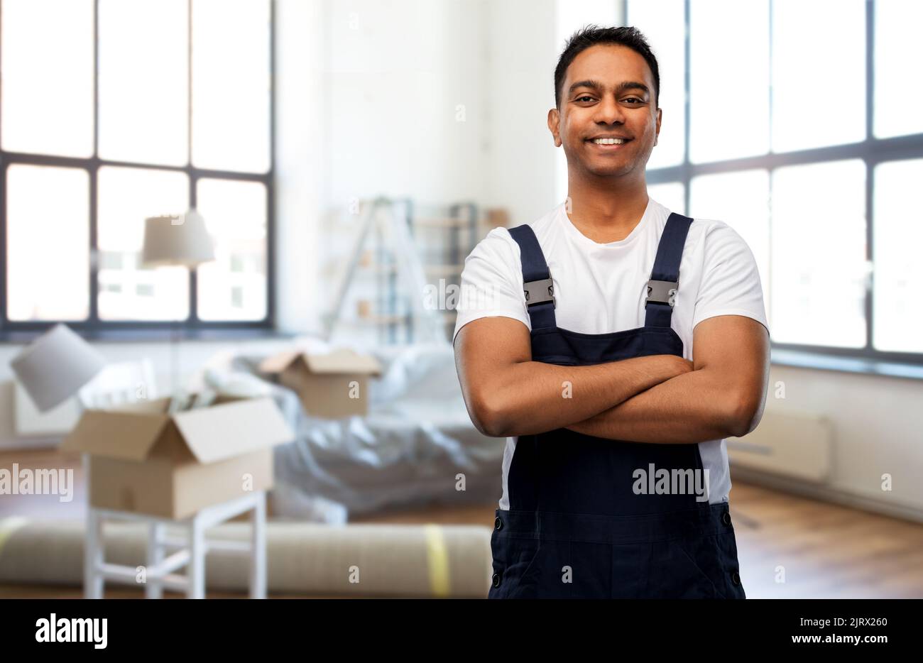 happy indian worker with crossed arms at new home Stock Photo - Alamy