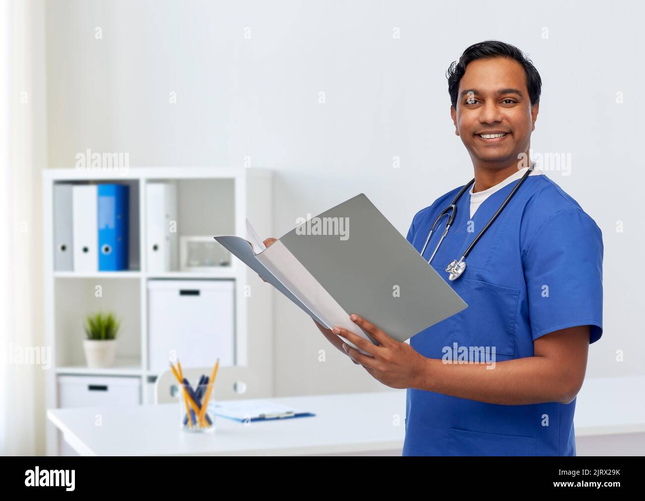 happy indian doctor with medical report in folder Stock Photo - Alamy