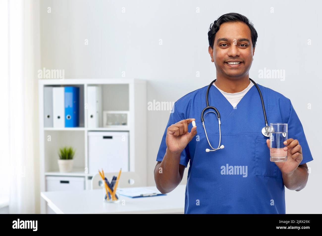 indian doctor with medicine and glass of water Stock Photo - Alamy