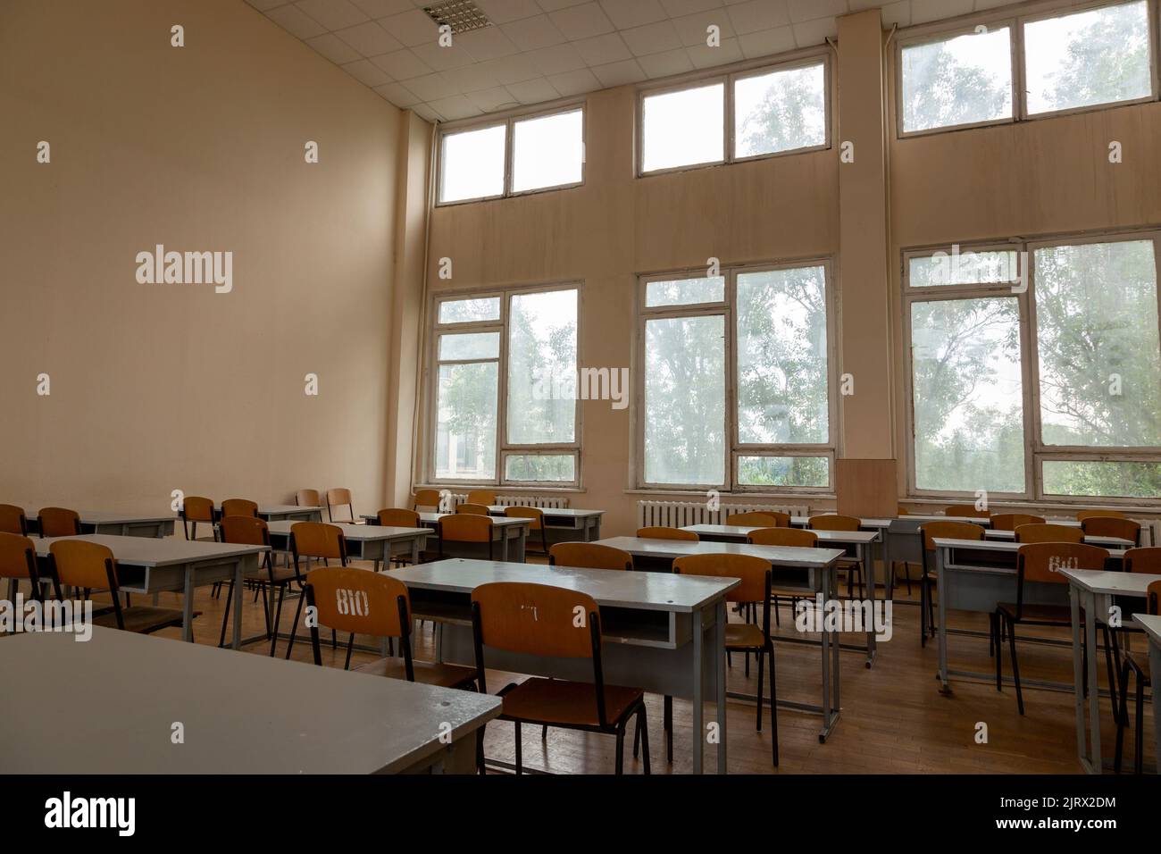 A fragment of the interior of the classroom with desks in an ...