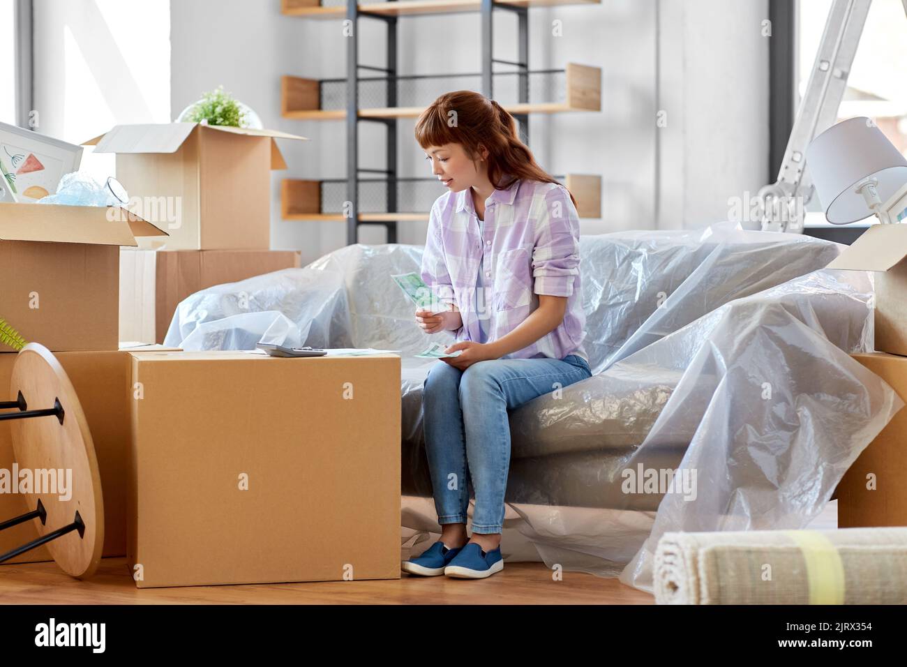 asian woman moving to new home and counting money Stock Photo - Alamy