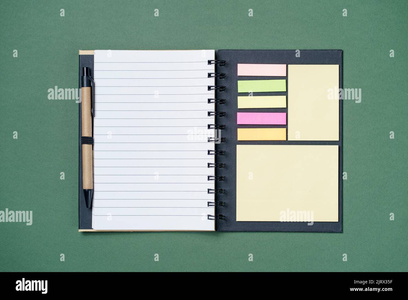 School notebook on a paper green background, spiral notepad and craft ...