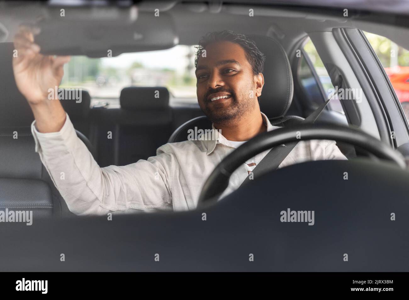 smiling indian man or driver driving car Stock Photo - Alamy
