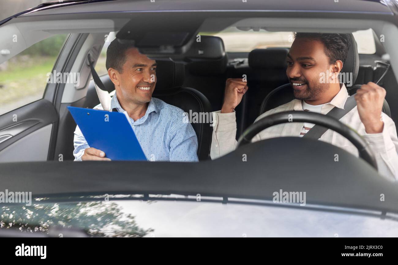 smiling car driving school instructor and driver Stock Photo - Alamy