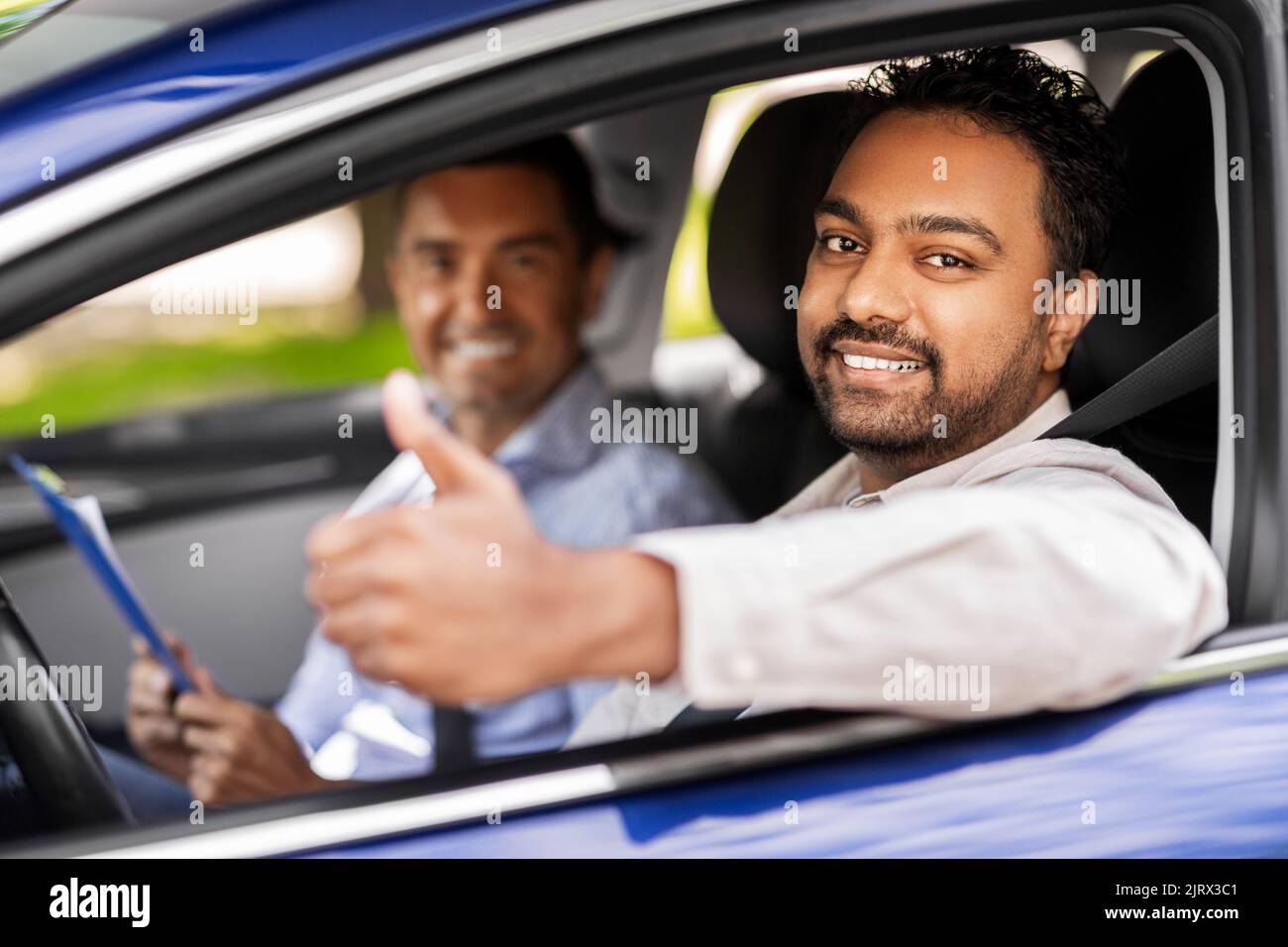 smiling driver and car driving school instructor Stock Photo - Alamy