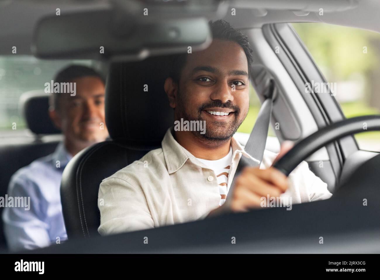 indian male driver driving car with passenger Stock Photo - Alamy