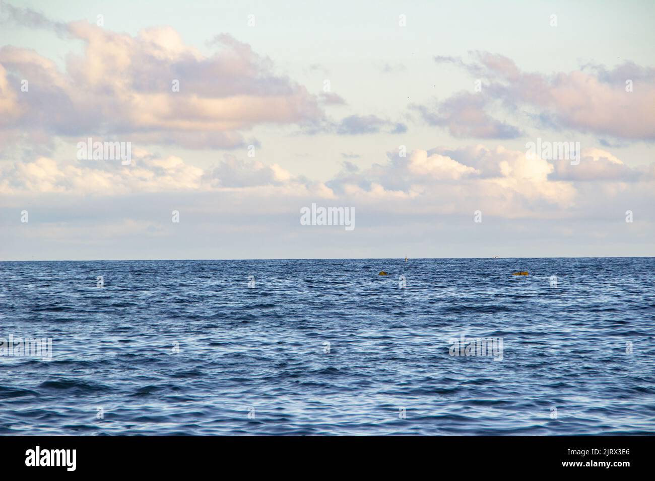 blue sea of copacabana beach in rio de janeiro with blue sky with some ...
