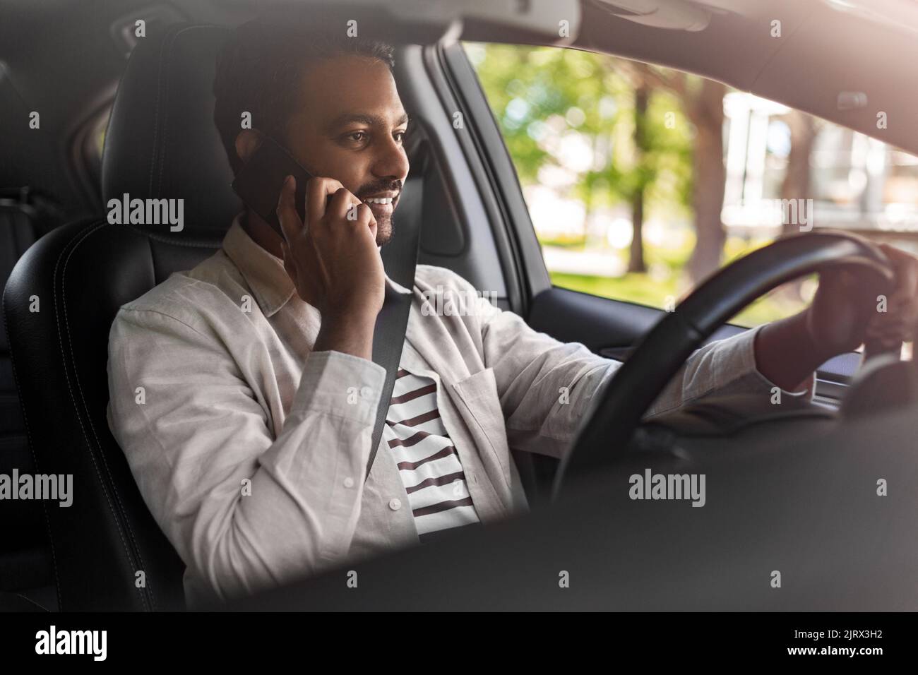 indian man driving car and calling on smartphone Stock Photo - Alamy