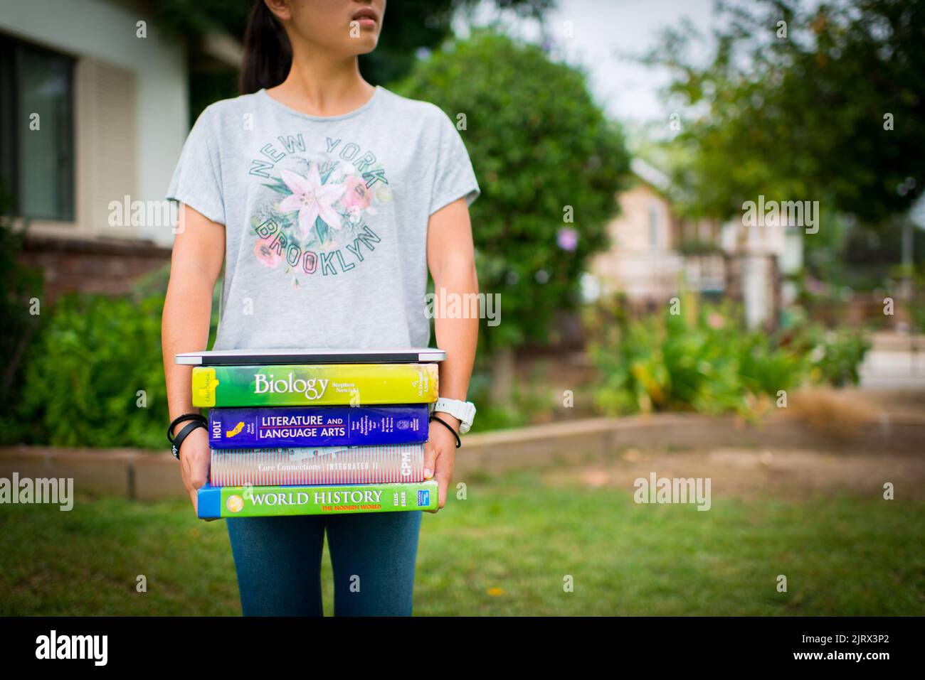 High school student with her textbooks Stock Photo - Alamy