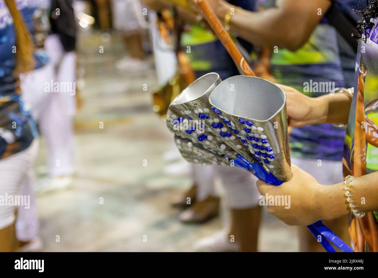 Components of the School of Samba portela playing the instrument agogô ...