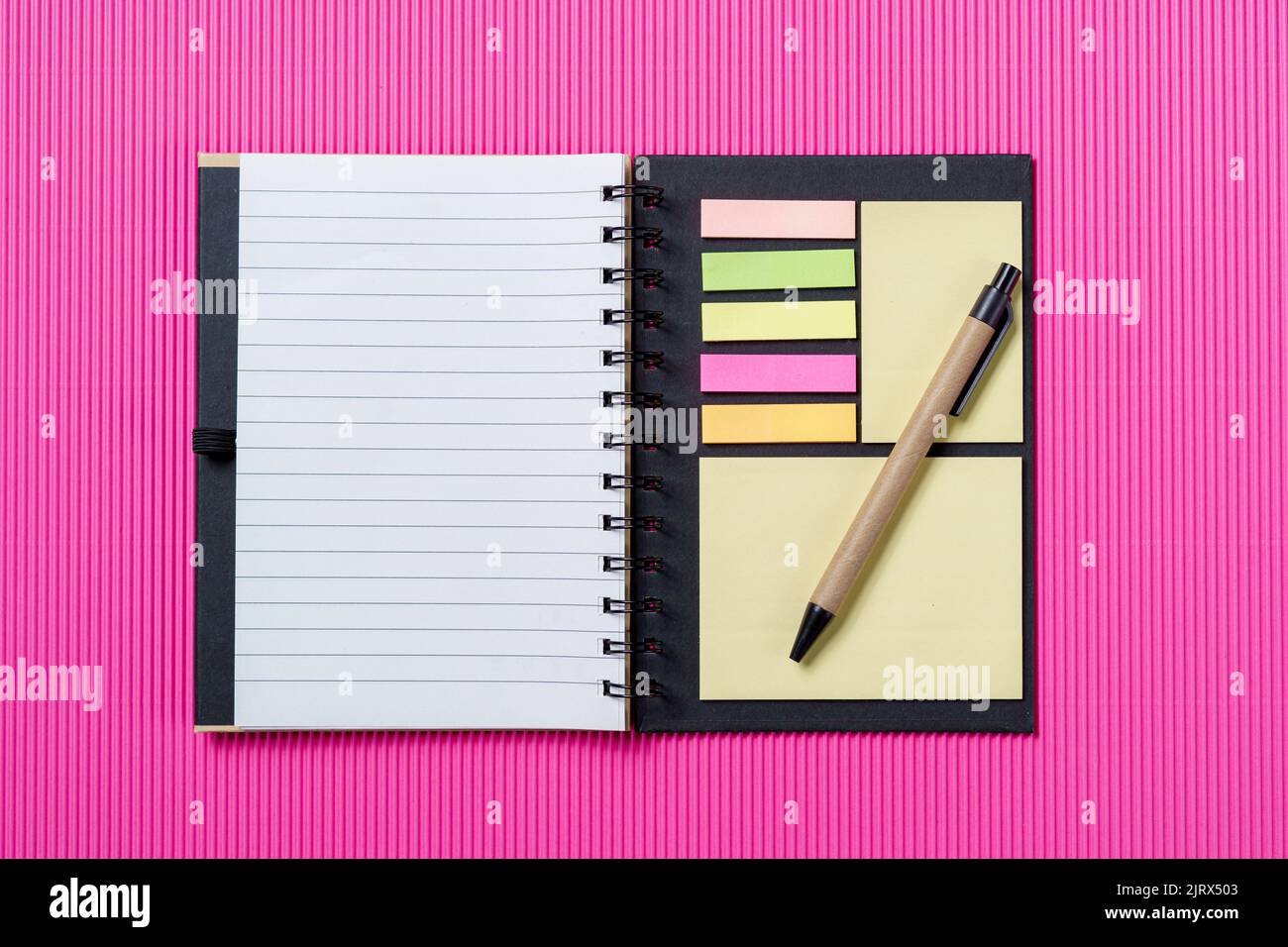 School notebook on a paper pink background, spiral notepad and craft ...