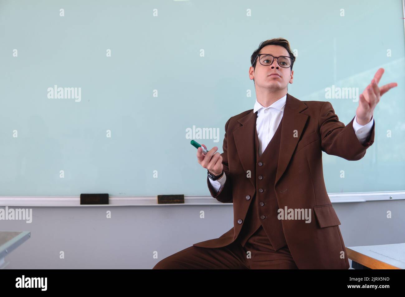 University professor asking the class. Elegant man in suit with glasses ...