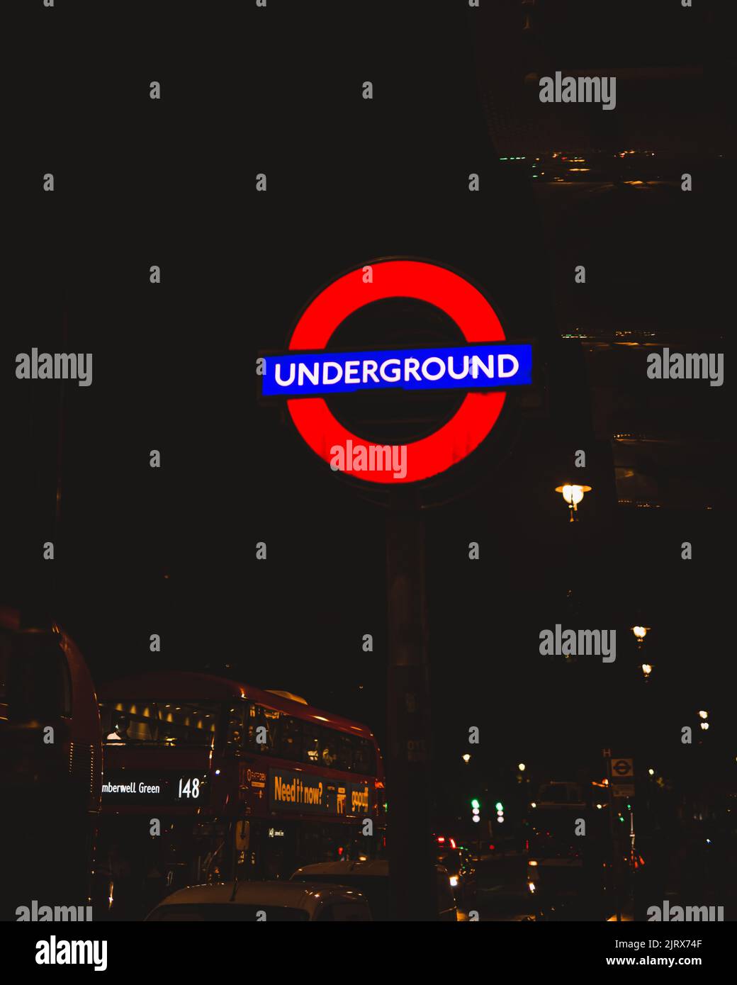 London Underground sign at night Stock Photo - Alamy