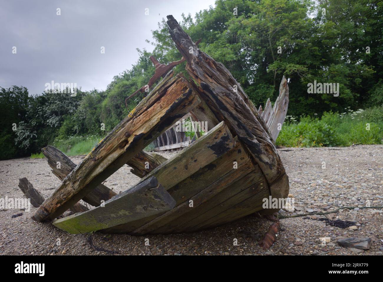 A wrecked wooden boat on a beach Stock Photo - Alamy
