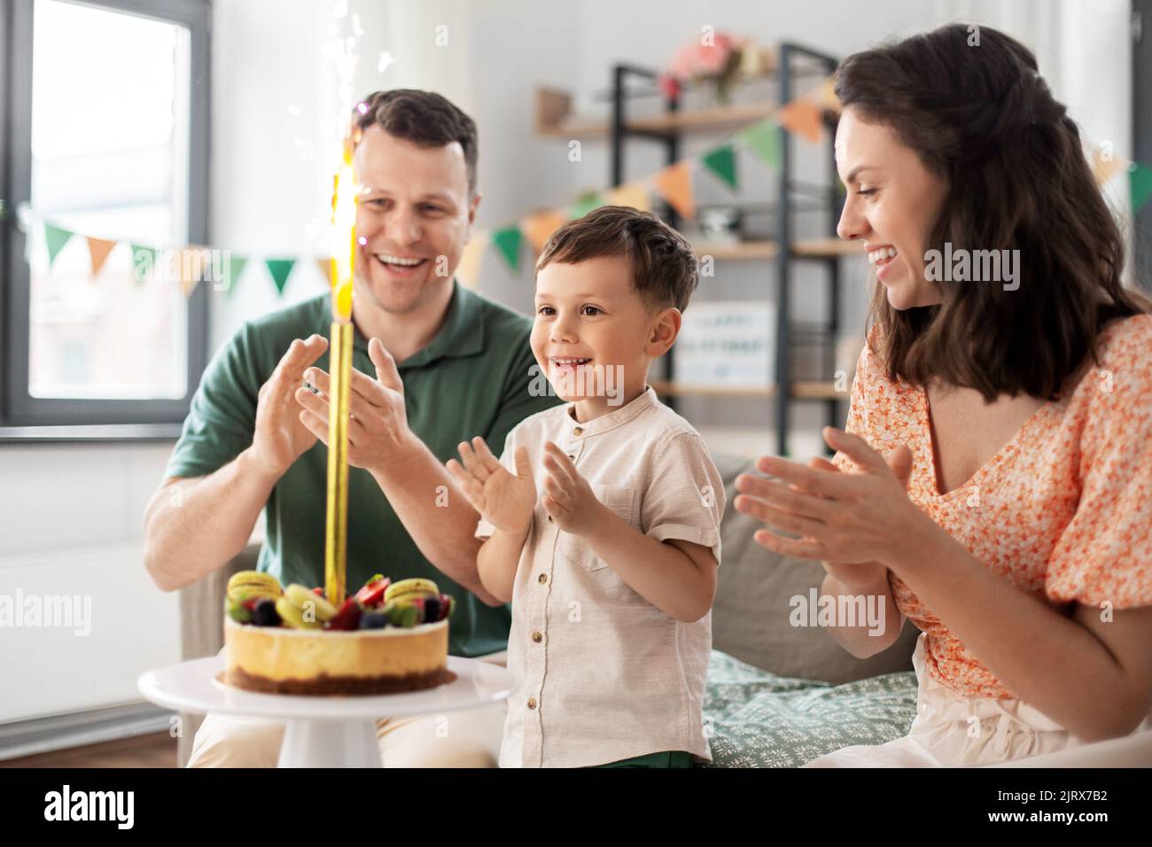happy family with birthday cake at home Stock Photo - Alamy