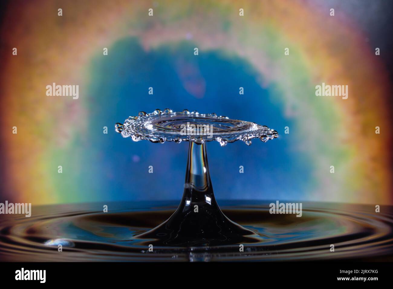 A scenic view of a water splash on a colorful background Stock Photo ...