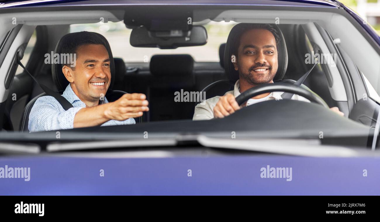 car driving school instructor teaching male driver Stock Photo - Alamy