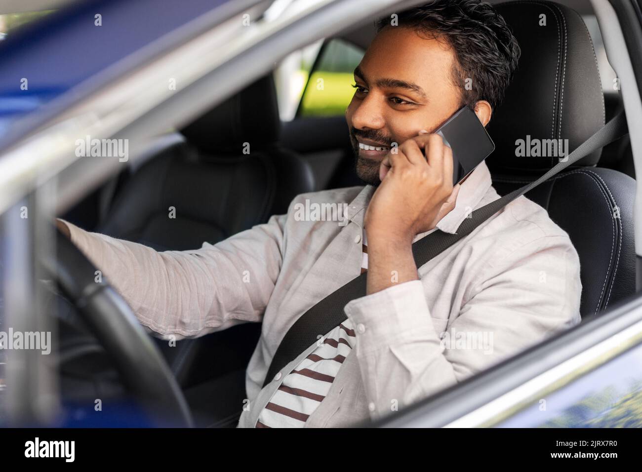 indian man driving car and calling on smartphone Stock Photo - Alamy