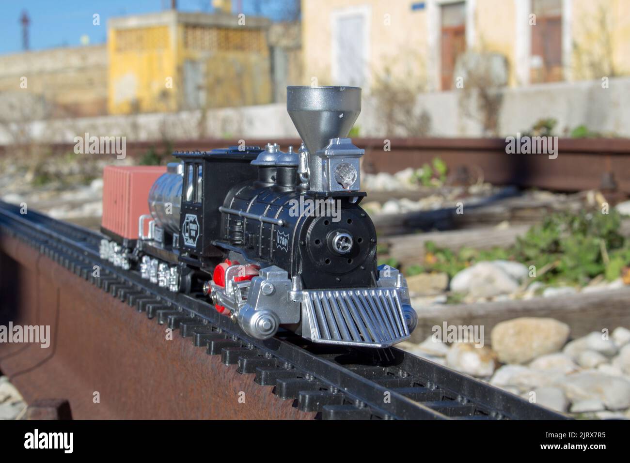Image of a toy train that runs on a real track at a train station Stock ...