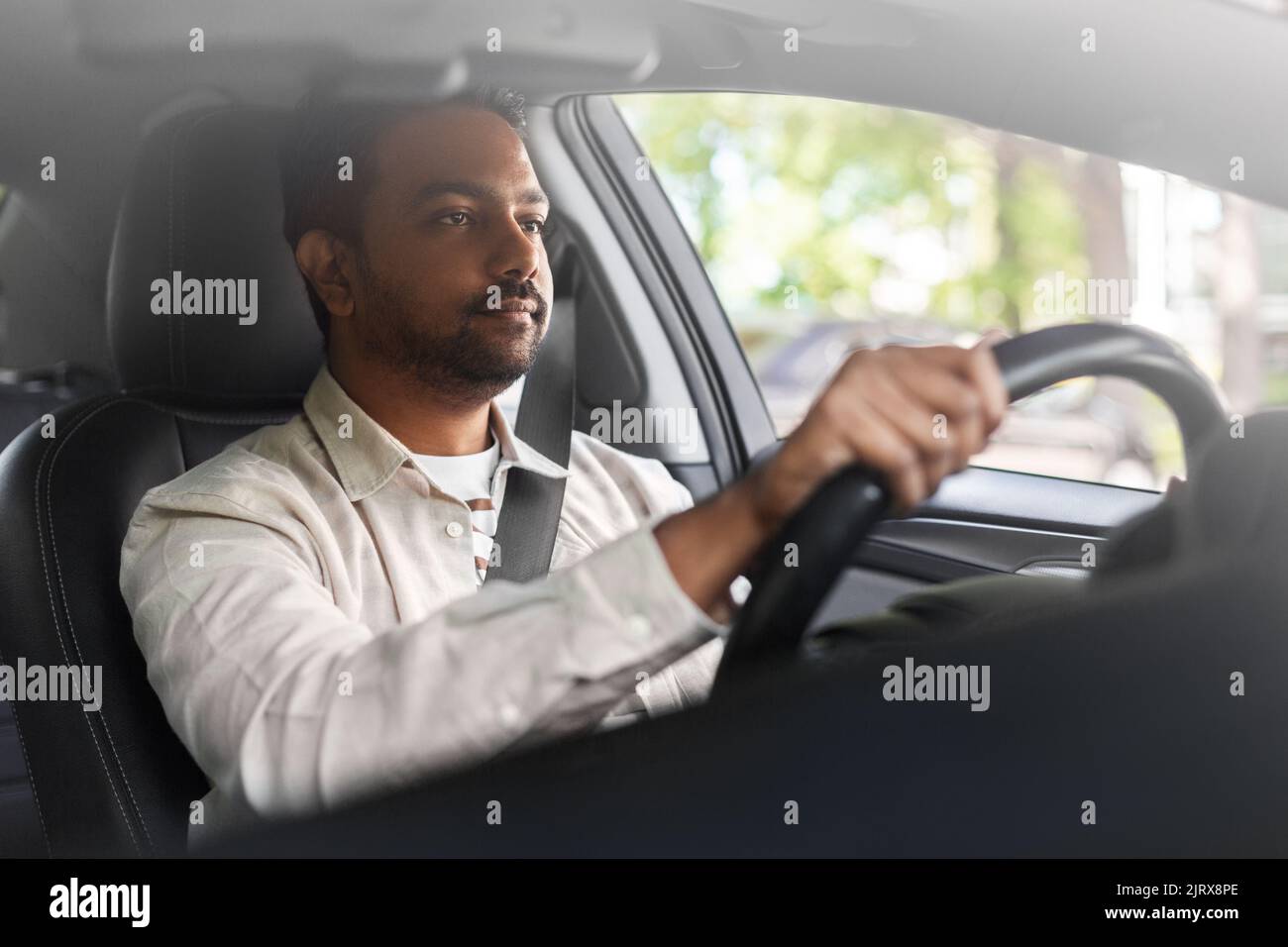 indian man or driver driving car Stock Photo - Alamy