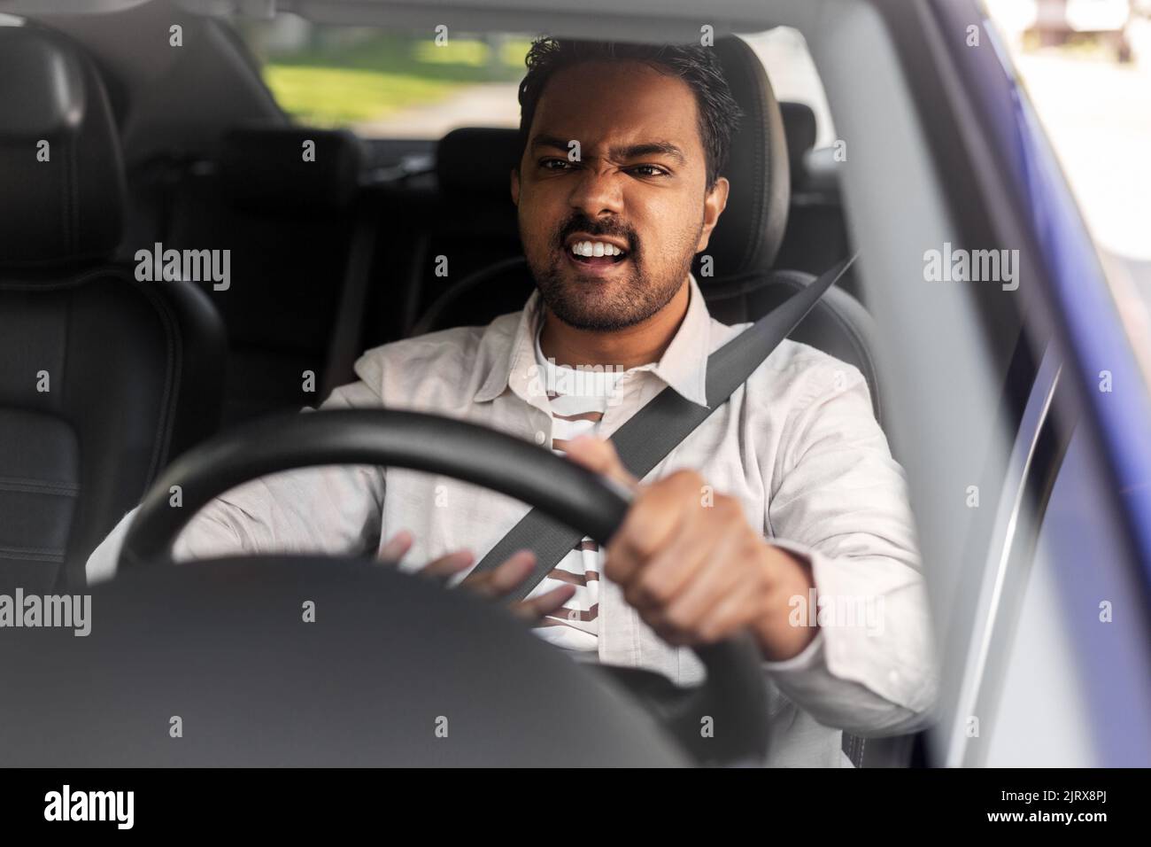 angry indian man or driver driving car Stock Photo - Alamy