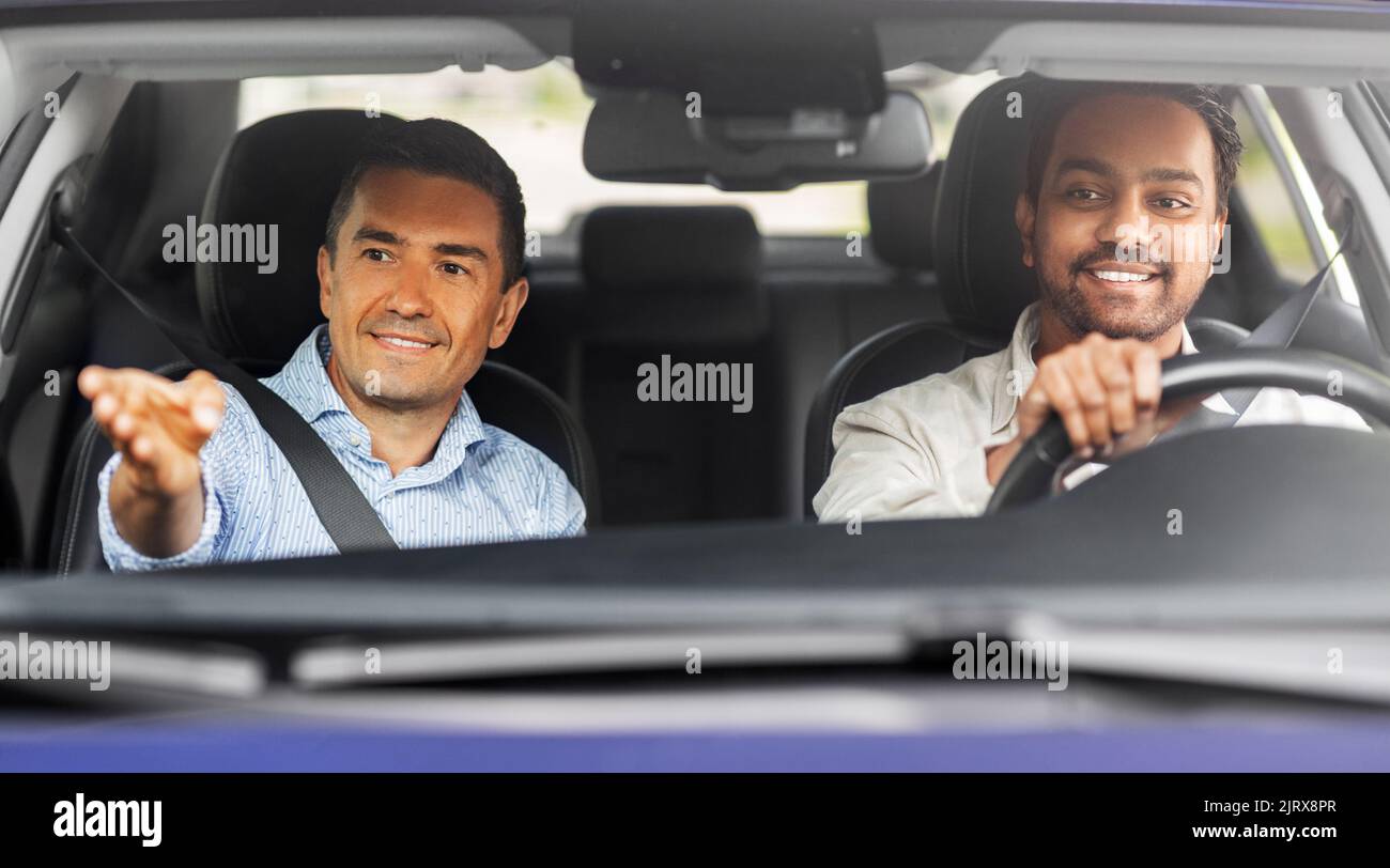 car driving school instructor teaching male driver Stock Photo - Alamy