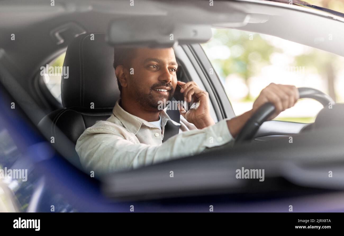 indian man driving car and calling on smartphone Stock Photo - Alamy