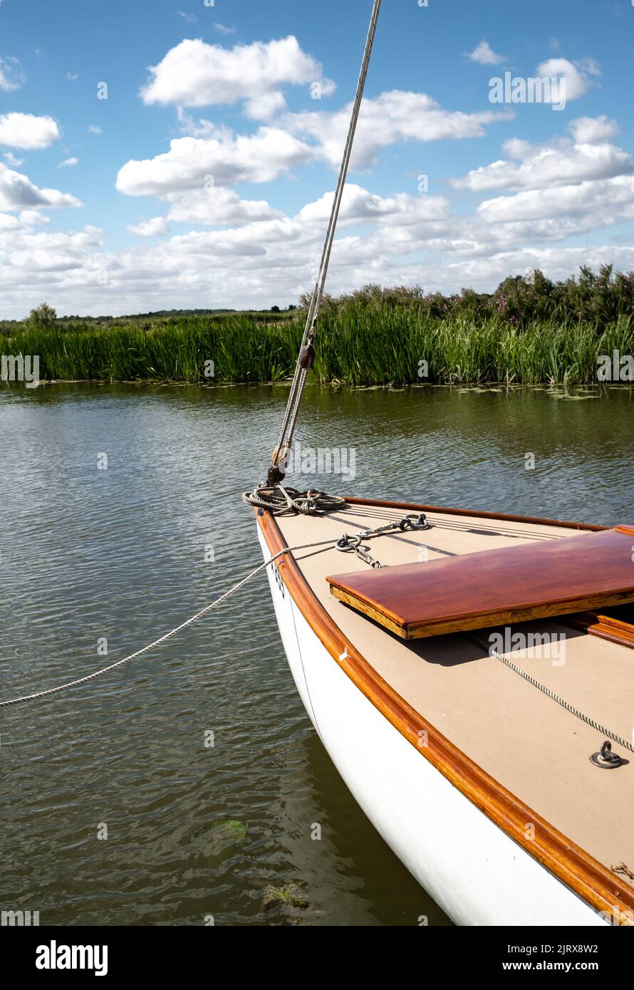 The front end or bow of a traditional sailing boat moored against the ...