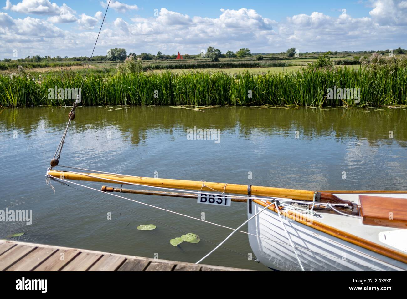 The front end or bow of a traditional sailing boat moored against the ...