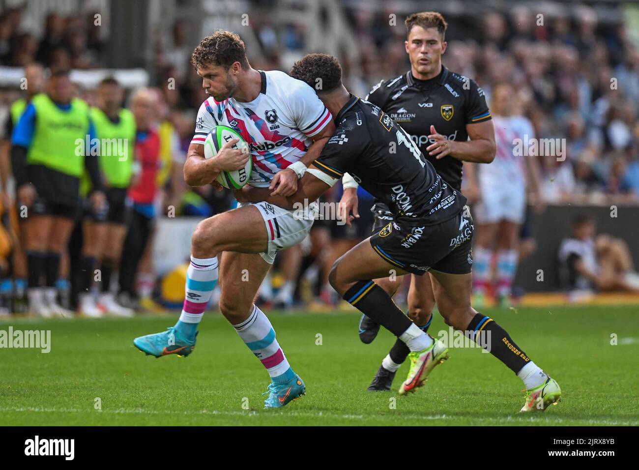 Henry Purdy of Bristol Bearsis tackled by Rio Dyer of Dragons Rugby ...