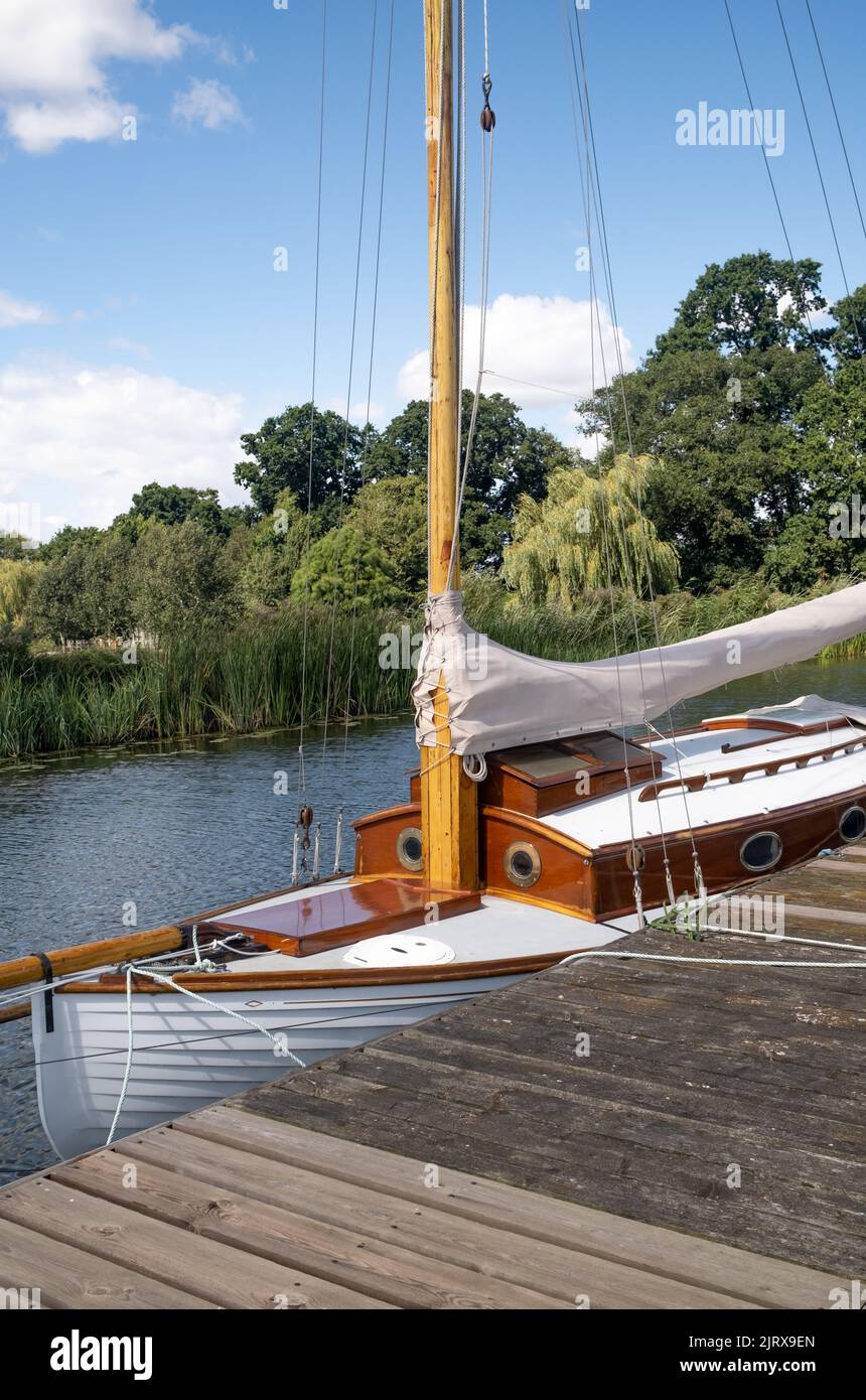Traditional sailing boat moored against the wooden quay heading Stock ...