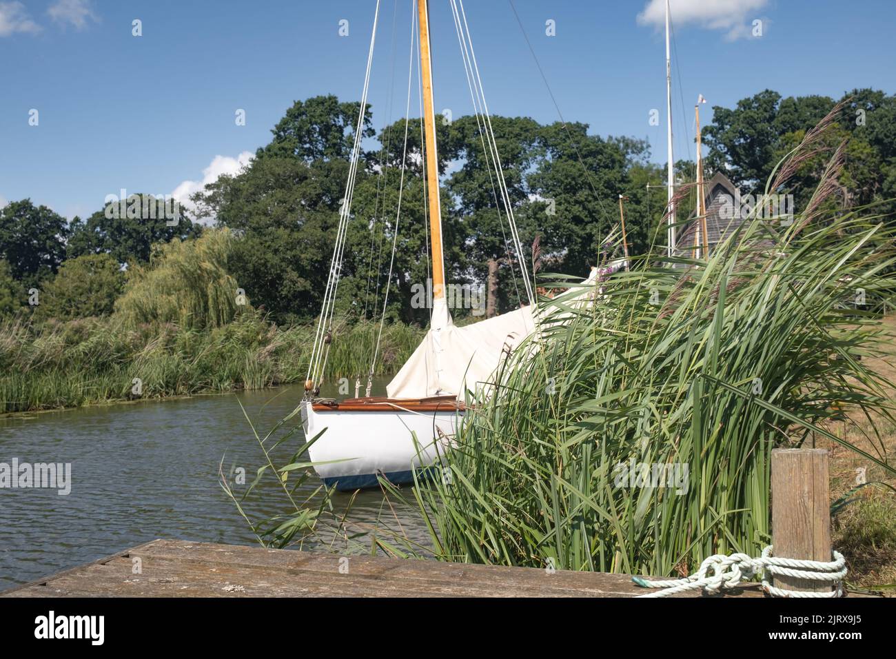 The front end or bow of a traditional sailing boat moored against the ...