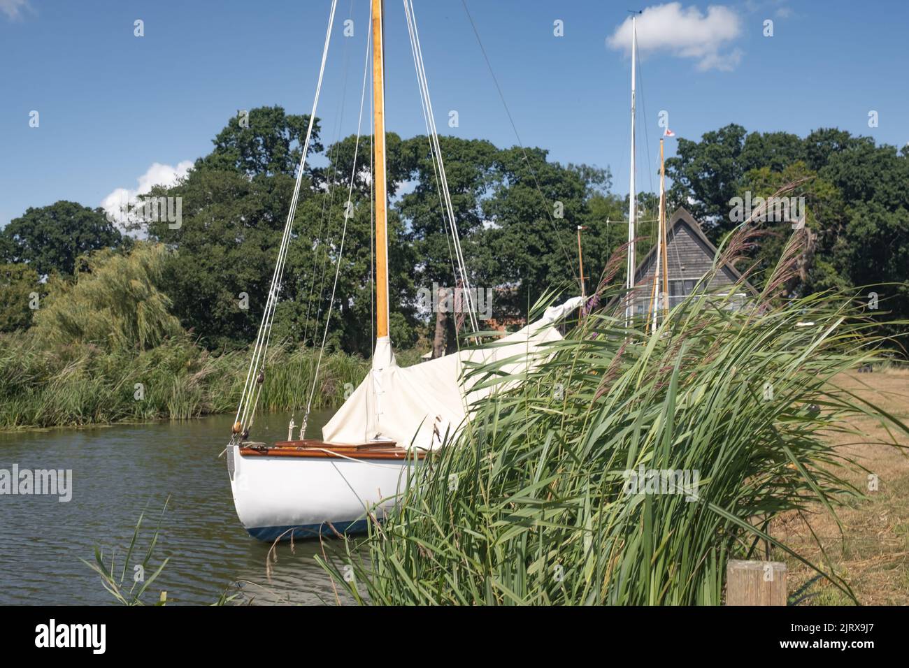 The front end or bow of a traditional sailing boat moored against the ...