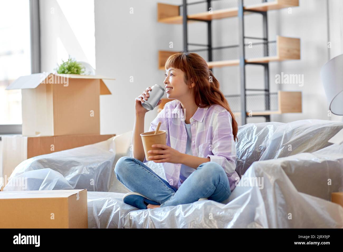 happy woman moving to new home and eating wok Stock Photo - Alamy