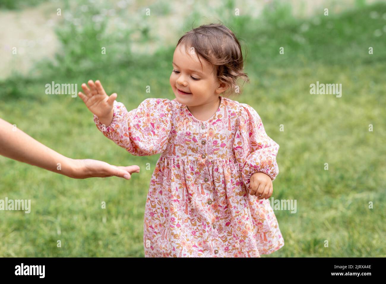Smiling child hand outdoors hi-res stock photography and images - Alamy