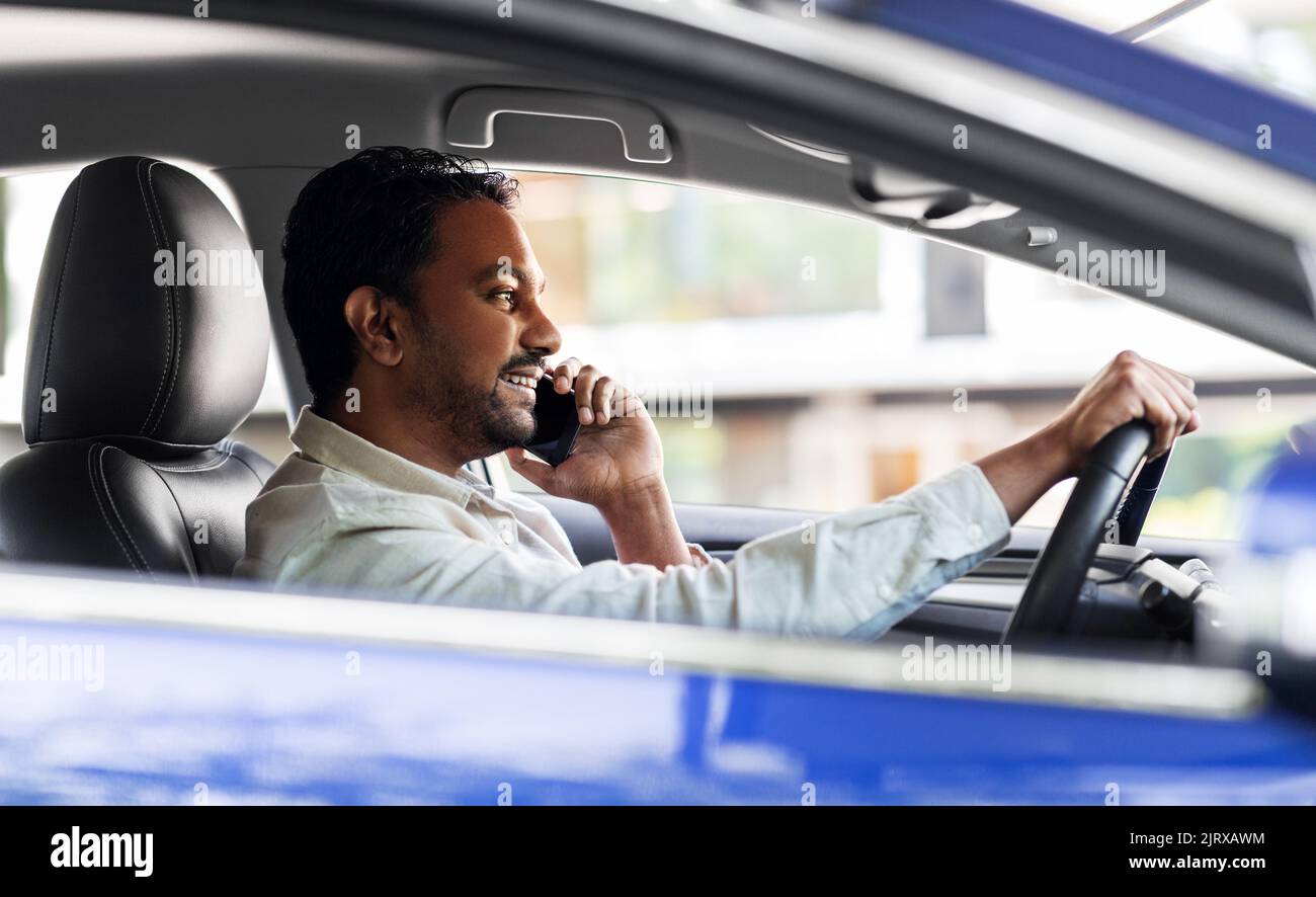 indian man driving car and calling on smartphone Stock Photo - Alamy