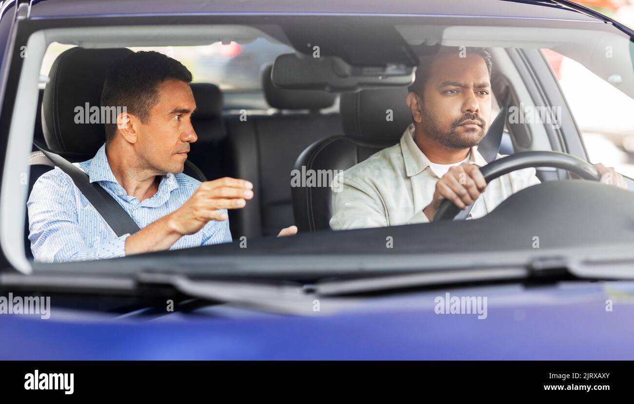 car driving school instructor teaching male driver Stock Photo - Alamy